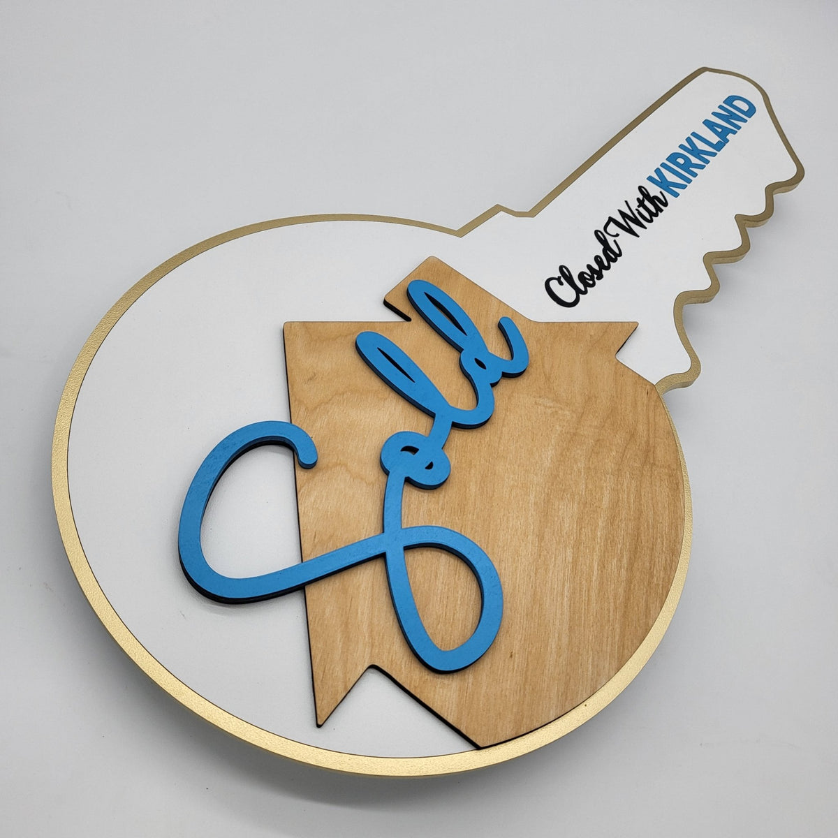 White Round Shaped Key Sign "Sold" – Real Estate Store